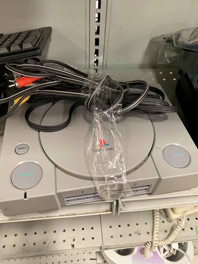 That PlayStation sitting there like a time machine back to 1995, controllers and nostalgia included.