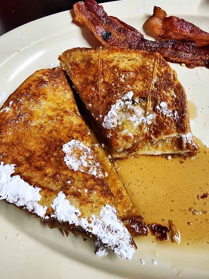 French toast dusted with powdered sugar alongside crispy bacon makes mornings worth waking up for early.