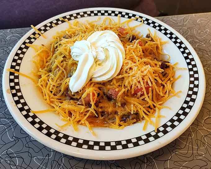 The Frito Pie arrives as a glorious mess of cheese, chili, and sour cream worth every napkin.