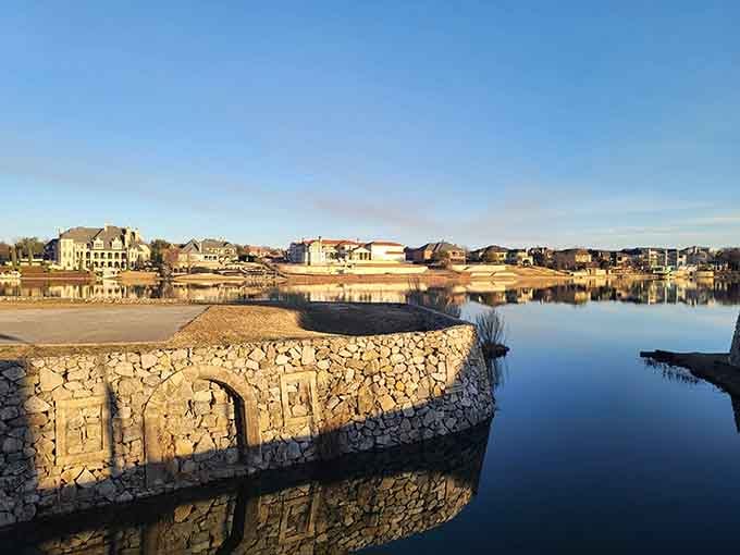 The tranquil waters mirror the charming European-inspired homes, making this lakeside scene feel like a storybook come to life.