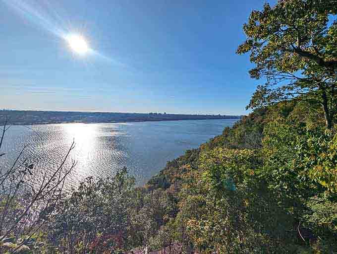 Sunlight dances on the water while the cliffs stand guard like ancient sentinels of serenity.