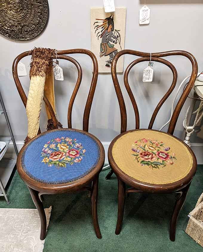 Hand-carved chairs with needlepoint seats that survived generations and still have plenty of stories left to tell.