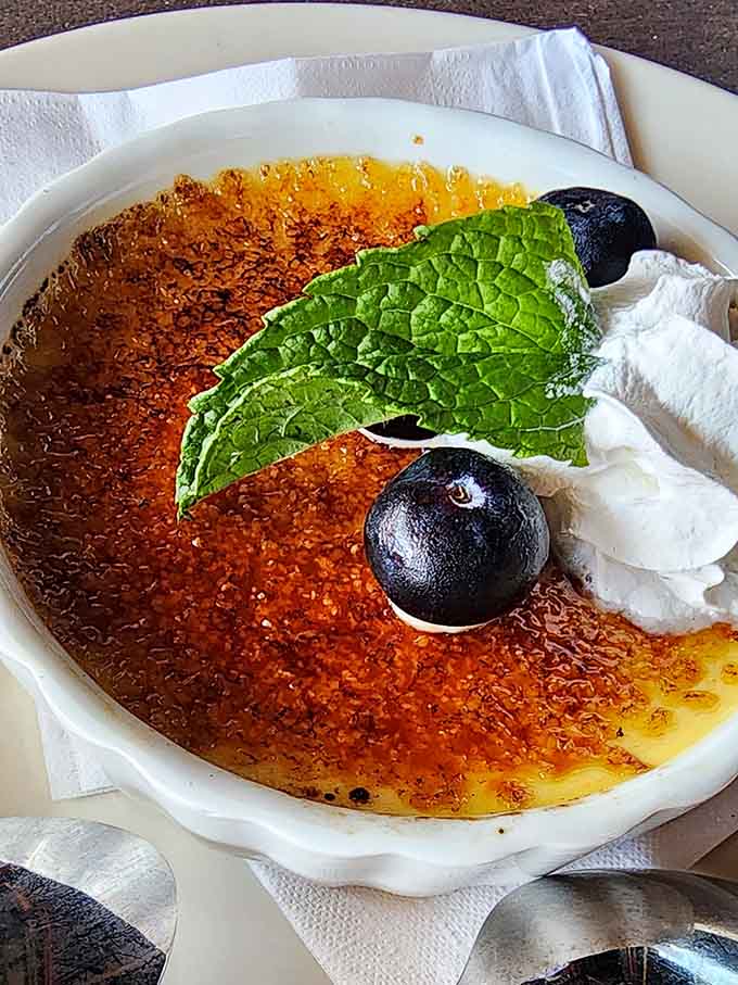 Cr&egrave;me br&ucirc;l&eacute;e with that perfectly caramelized top that cracks like culinary ASMR when you tap it.
