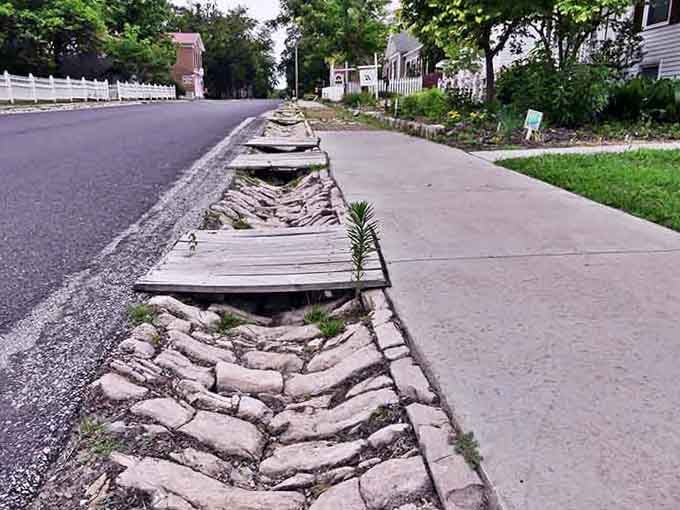 These stone gutters have been directing rainwater longer than most countries have had paved roads and indoor plumbing combined.