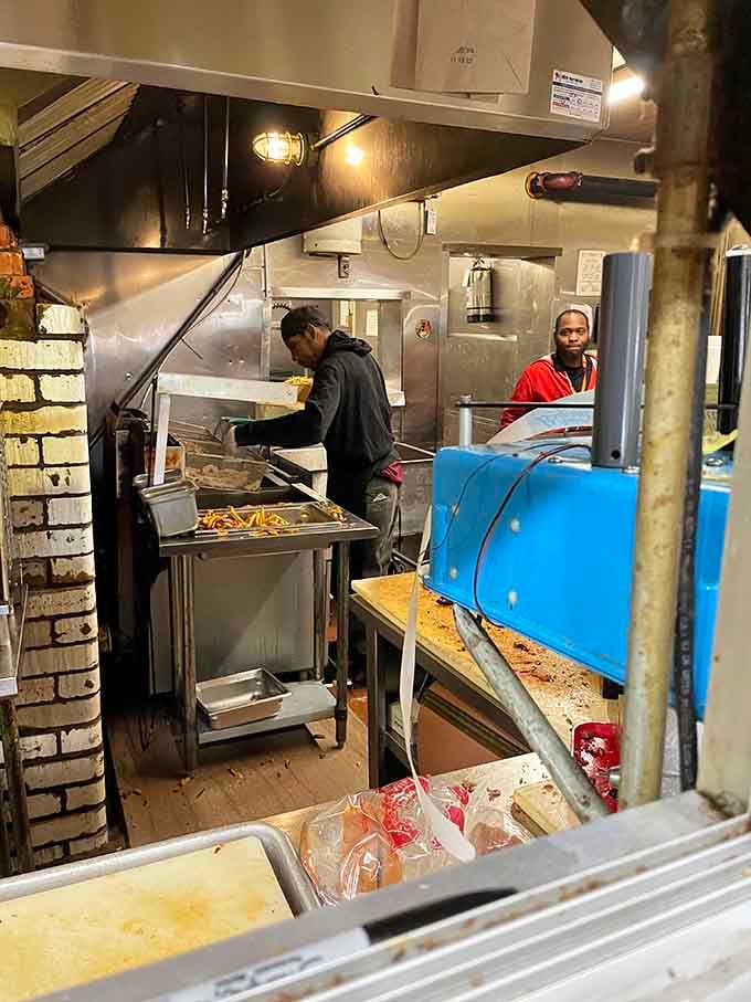 Behind the counter, the real work happens: smoke, fire, and patience transforming meat into something transcendent and unforgettable.