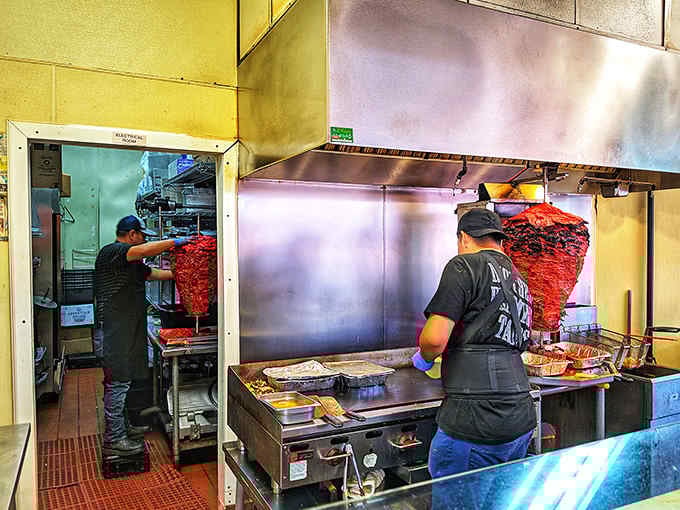 Behind the counter, the trompo spins like a delicious beacon, promising tacos that'll make your day infinitely better.
