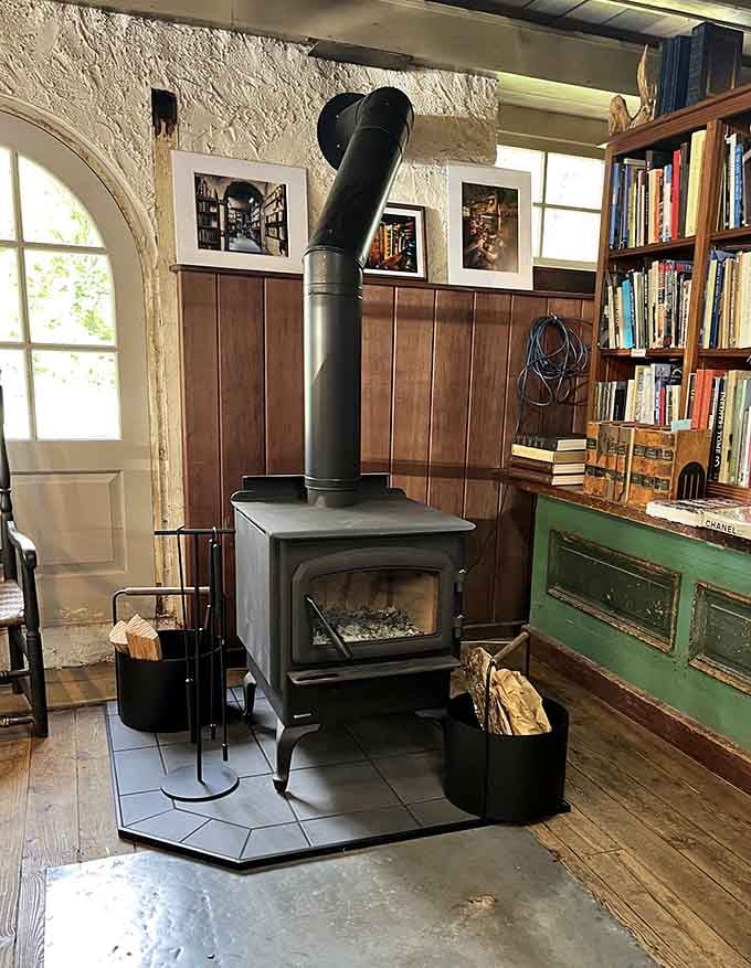 A wood stove for chilly days proves this barn understands that books and warmth go together.