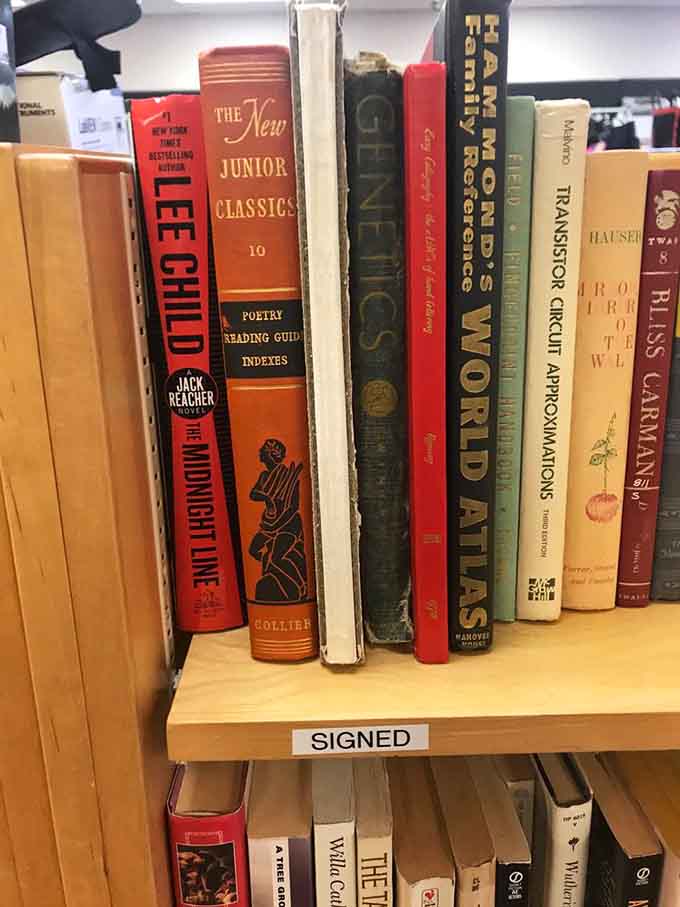 Books lined up like old friends, including signed editions that make collectors do a double-take.
