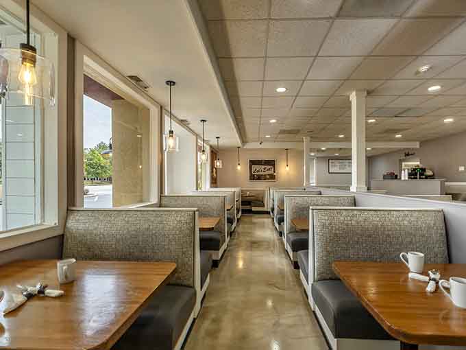 Rows of booths stretching toward natural light create that perfect diner geometry where memories get made over meals.