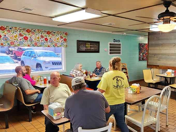 Framed artwork and community photos on wood-paneled walls tell stories of a place that's earned its local stripes.