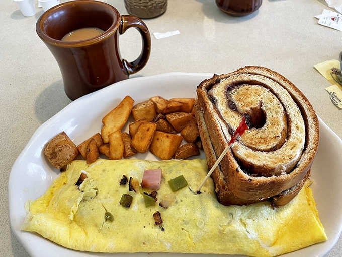 That omelet paired with home fries and a cinnamon roll the size of your head is breakfast done with serious commitment.
