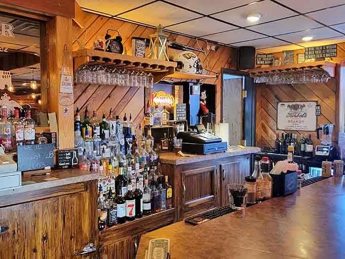 The bar area features wood paneling and a well-stocked selection for those who appreciate a proper pre-dinner cocktail.