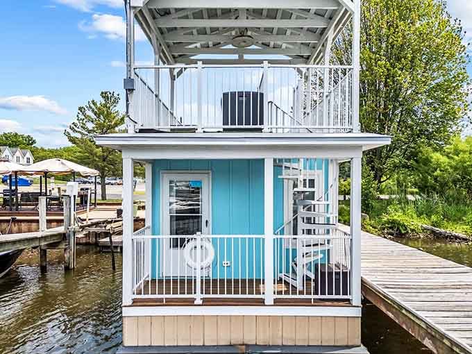 That spiral staircase to the rooftop deck adds architectural flair while the aqua siding practically glows with cheerful charm.