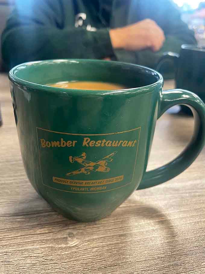 That green Bomber mug holds liquid motivation strong enough to power you through any Michigan morning ahead.
