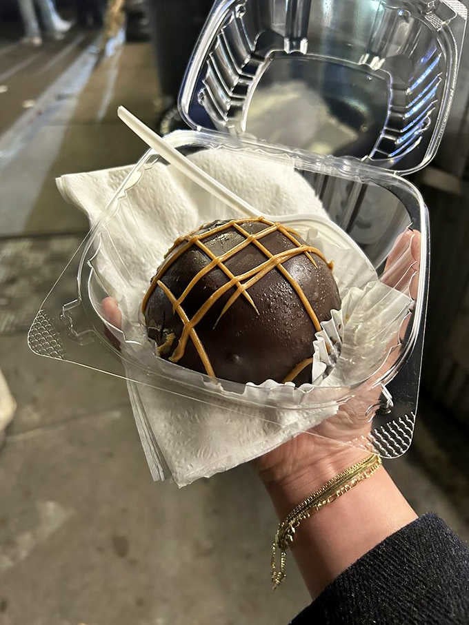 That peanut butter bomb looks like it survived a chocolate meteor shower and came out absolutely victorious.