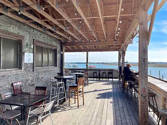 Mismatched chairs and simple tables prove that comfort has nothing to do with matching furniture sets and everything to do with honest hospitality.