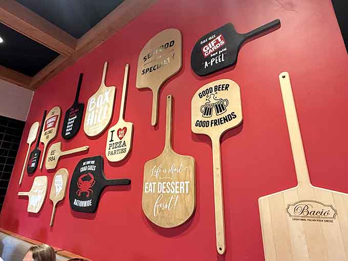 Pizza peels on the wall celebrate carbs and crustaceans equally, declaring this a judgment-free zone for hungry souls.