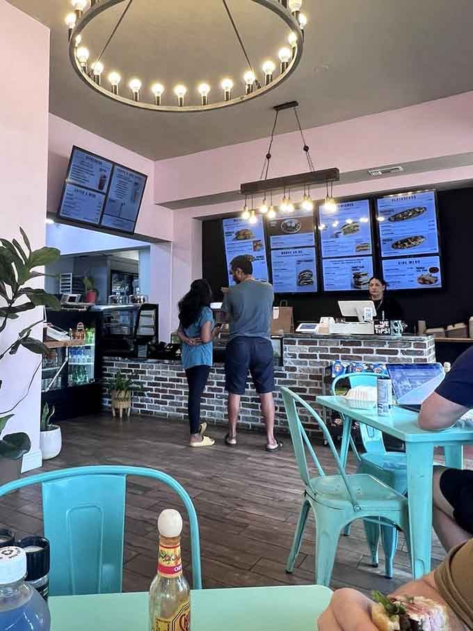 Real people ordering real sandwiches in a real spot where the turquoise chairs match the laid-back Tampa energy.