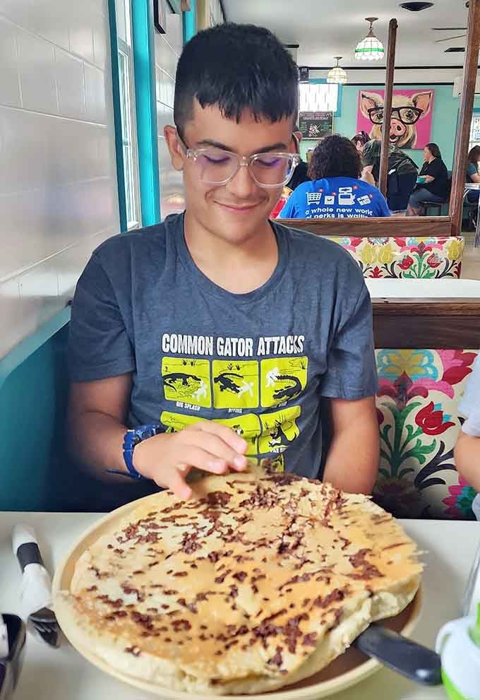 That smile says it all when you're facing down a chocolate chip pancake bigger than your head.