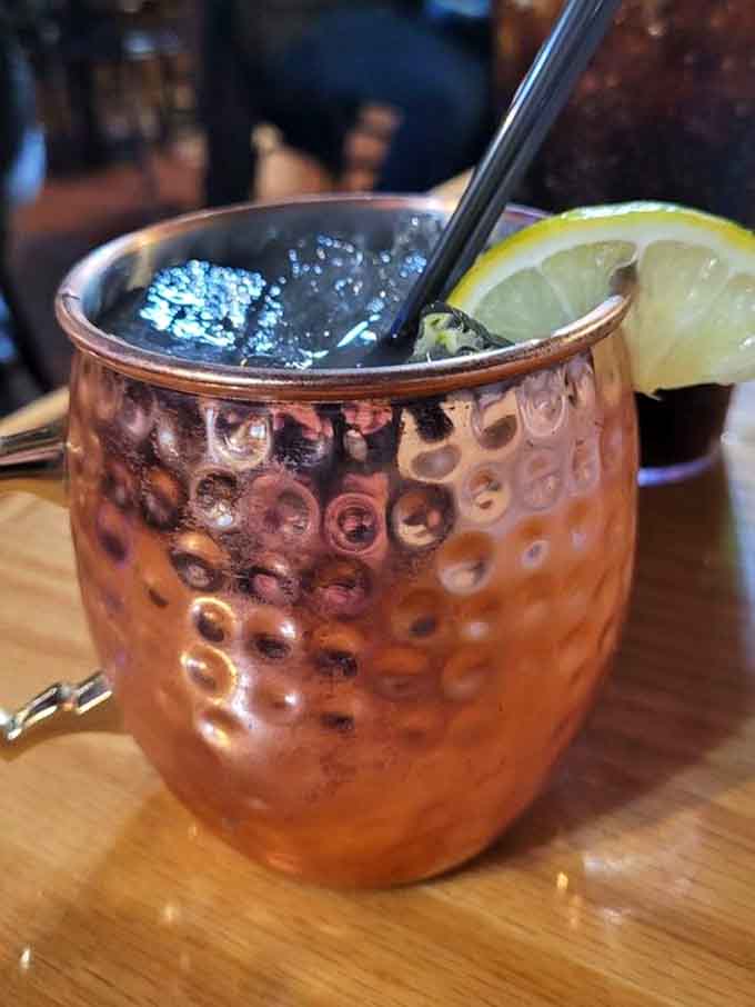 The copper mug catches light like a treasure chest, promising refreshment with every frosty sip inside.