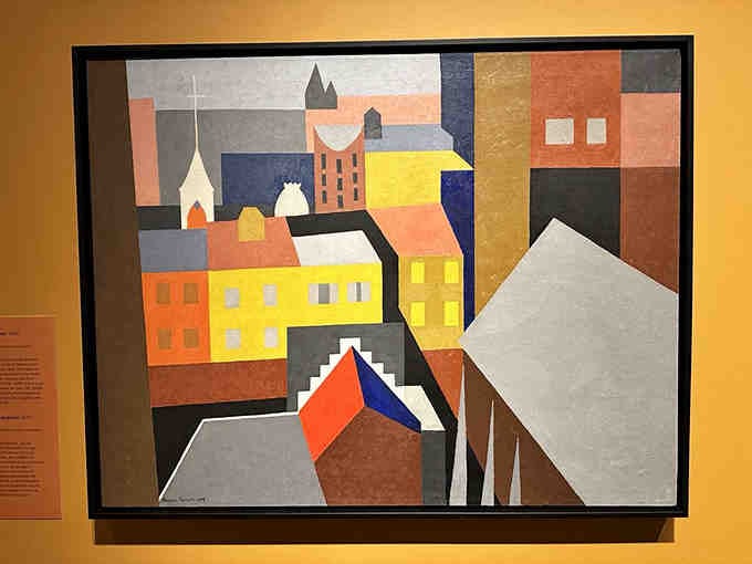 Geometric abstraction meets small-town charm in this vibrant piece that proves modern art doesn't have to be intimidating.