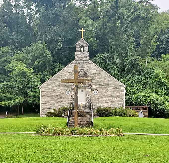 A small church nestled in green mountains, looking exactly like every peaceful postcard you've ever seen.