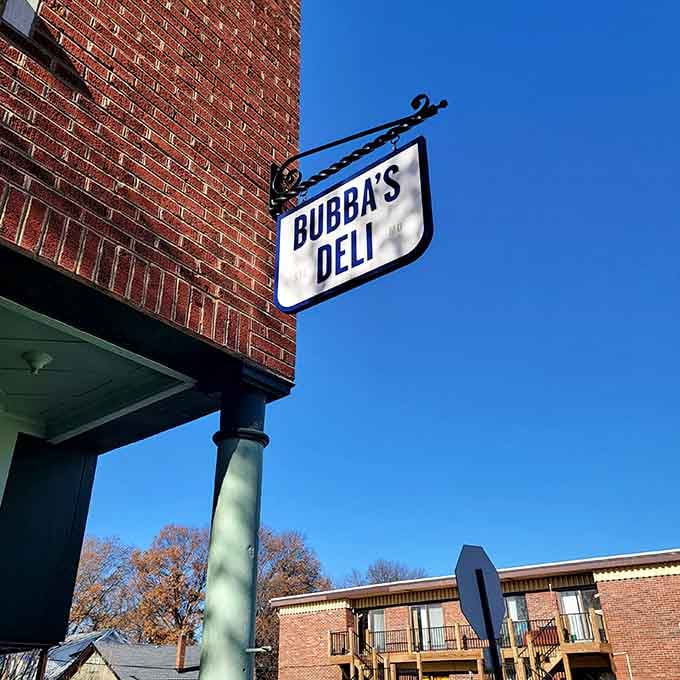 That classic sign hanging proud against blue sky promises good things await inside below.