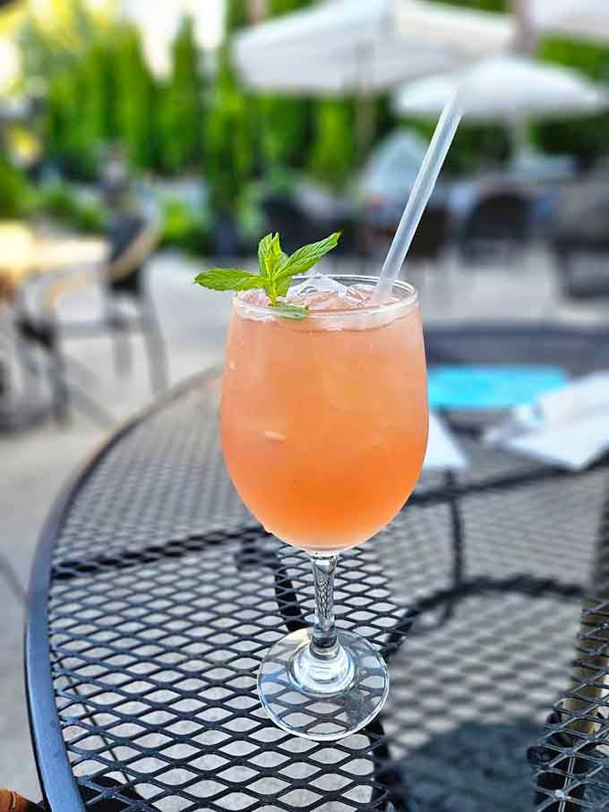 That mint sprig garnish and peachy glow suggest this refreshing sipper knows exactly how to complement a warm afternoon perfectly.