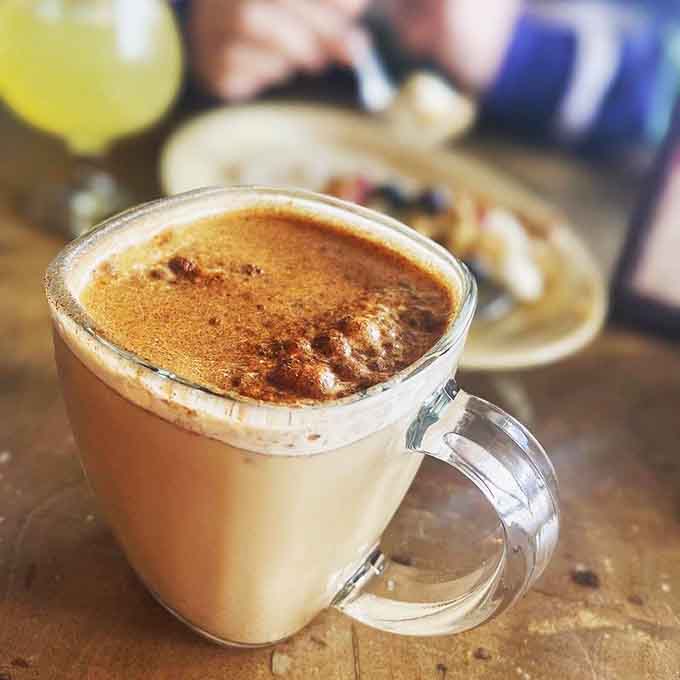 That frothy latte is the kind of coffee companion that makes early mornings feel like a privilege.