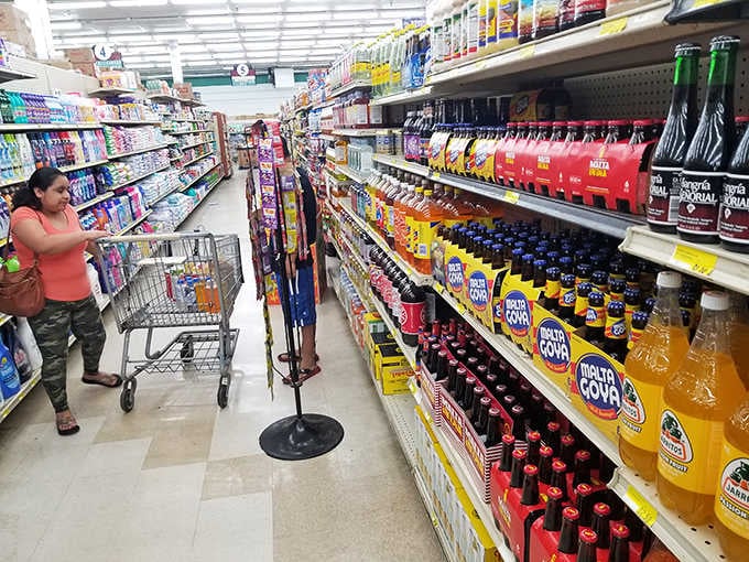 Colorful beverage bottles line the aisle like a United Nations meeting, each representing its homeland with pride and flavor.