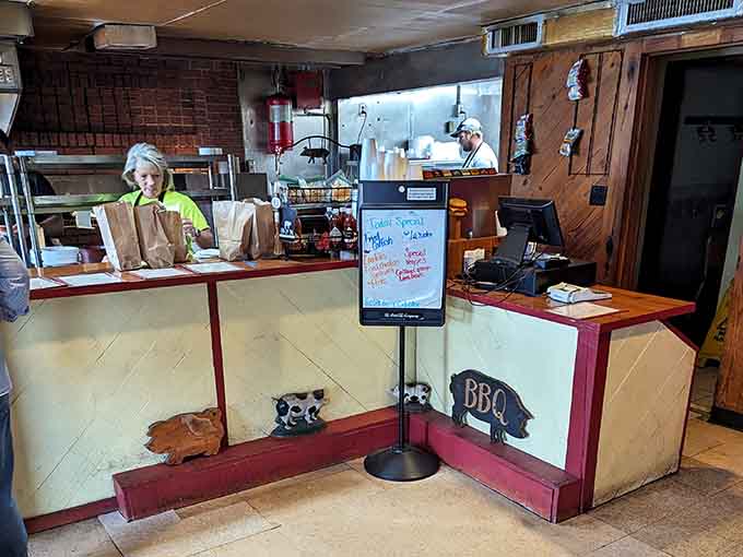 The order counter decorated with pig cutouts sets a playful tone before your serious eating begins shortly.
