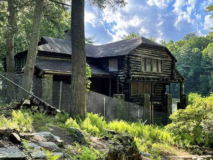 A weathered log cabin stands as a rustic reminder of the mountain's storied past and simpler times.