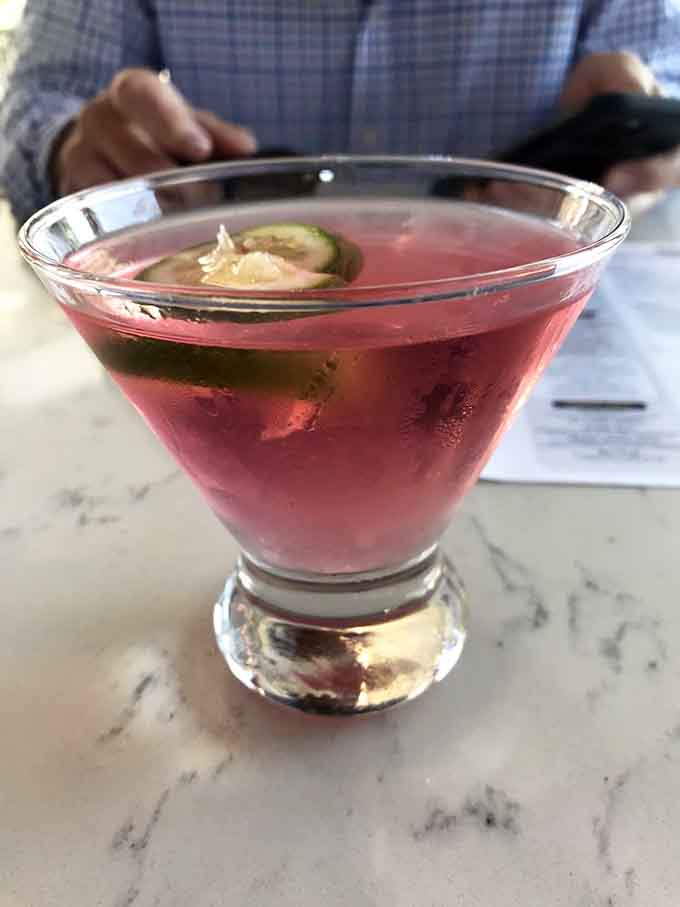 That ruby-red cosmopolitan catches the light beautifully, proving cocktails can be both classic and Instagram-worthy simultaneously.
