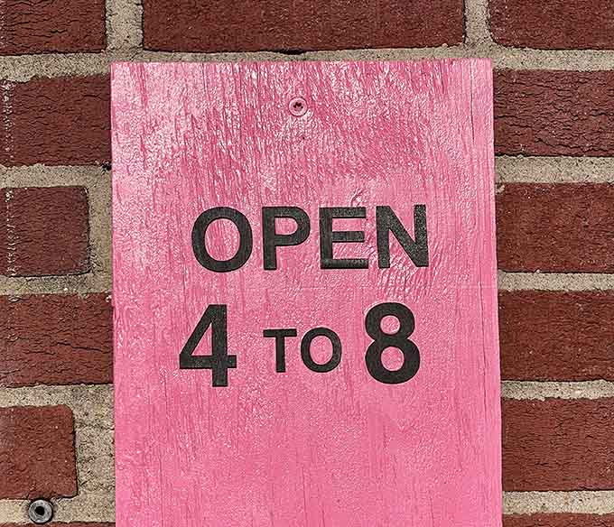 Pink signage announcing 4 to 8 hours, the sacred window when burger dreams come true in Foley, Alabama.