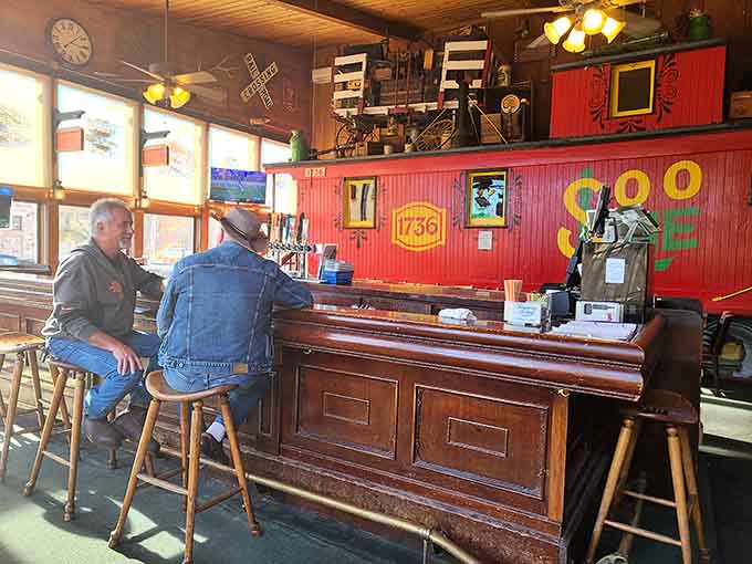 The wooden bar invites you to settle in for a cold one while that red caboose steals the show.