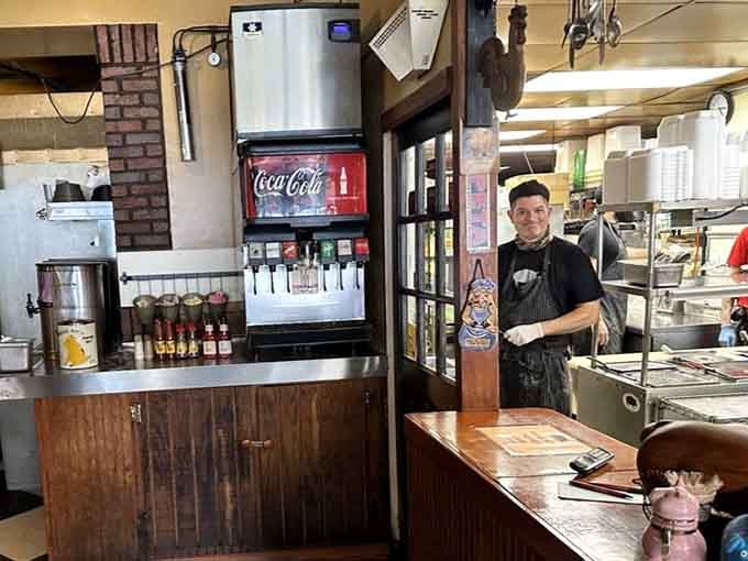 Behind that counter stands someone who understands that slicing brisket properly is both science and performance art combined.