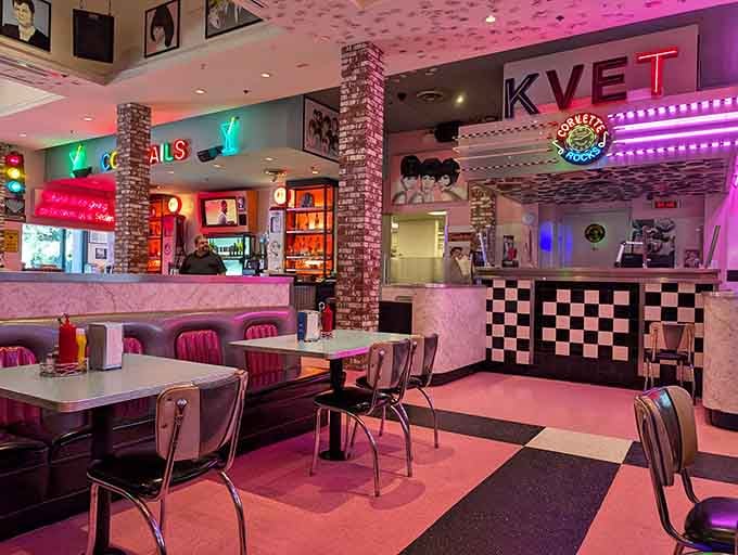 Pink booths and neon glow create an atmosphere where calories don't count and everyone's secretly seventeen again inside.