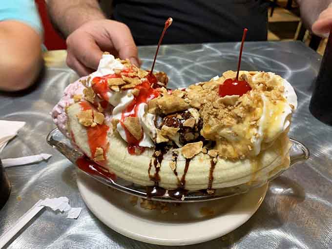A banana split that looks like it escaped from a 1950s soda fountain and landed in dessert heaven.