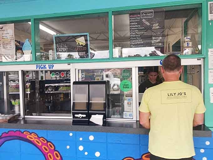 A sunny Florida pick-up window where locals and travelers alike queue for Lily Jo's casual coastal eats and island vibes.