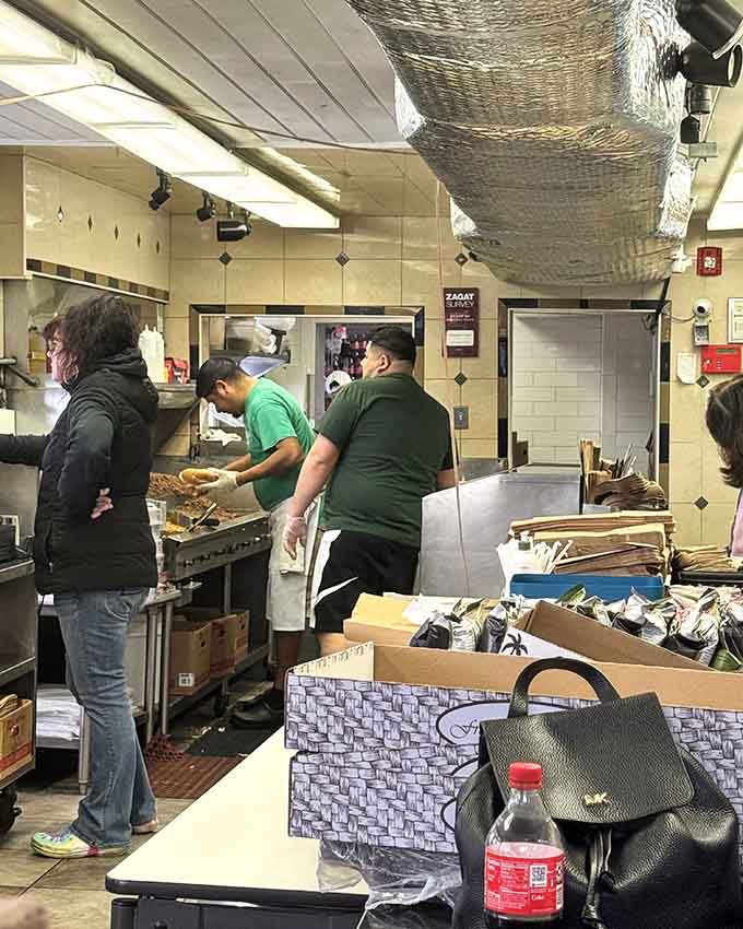 Behind the counter, the griddle sizzles with beef while experienced hands work with the efficiency of a Formula One crew.