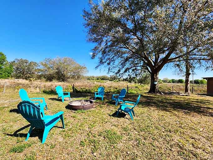 Turquoise Adirondack chairs circling a fire pit where s'mores and stargazing become the evening's main entertainment.