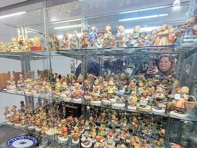 Hundreds of tiny figurines crowd the shelves like the world's most adorable antique convention, each face uniquely charming.