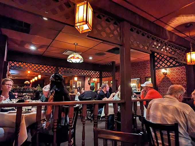 That patterned wallpaper and warm lighting create an ambiance that's pure supper club magic at its finest.