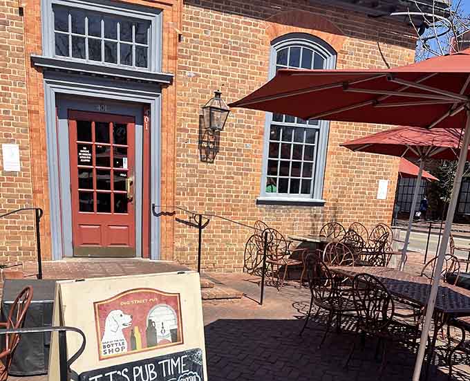 The brick exterior and welcoming patio furniture under orange umbrellas create an atmosphere that says "stay awhile" in the best possible way.