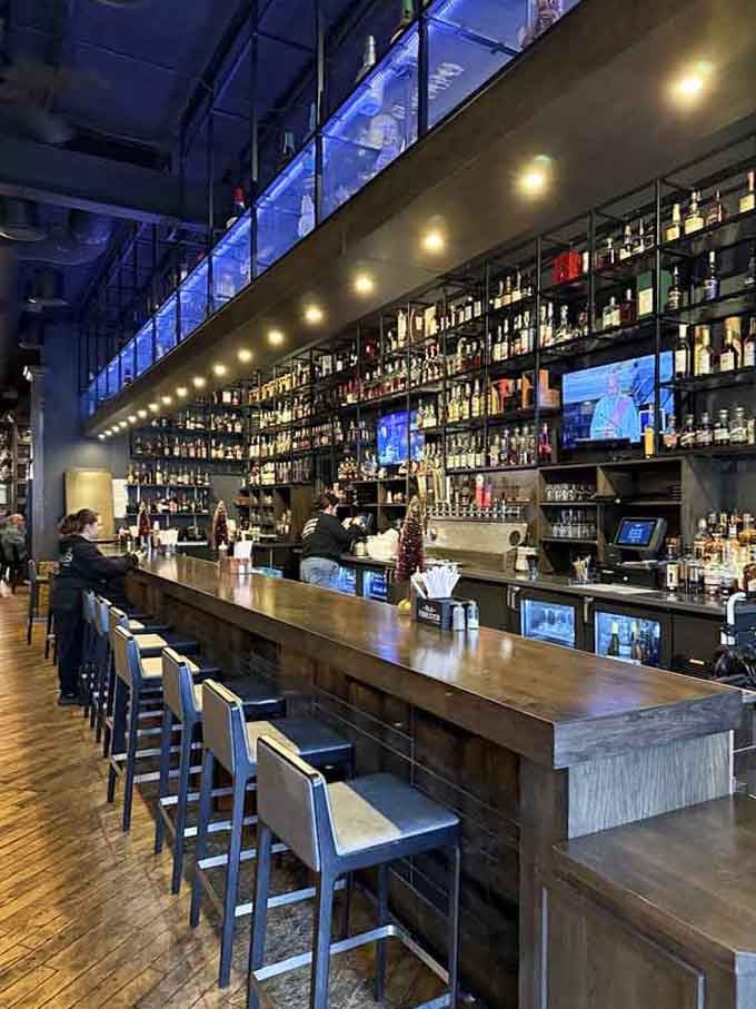 A bourbon wall that stretches to the ceiling like a library for people with better taste in literature than books.