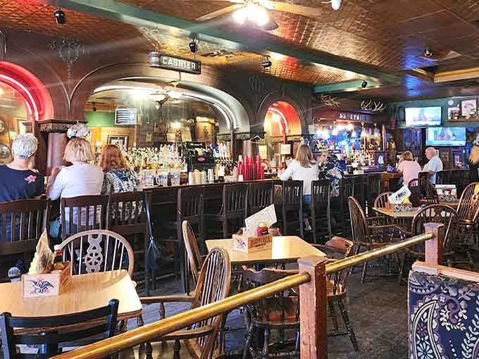The bar area serves as the social heart of the tavern, where locals and visitors gather under vintage signage and Western memorabilia that's genuinely worth examining closely.