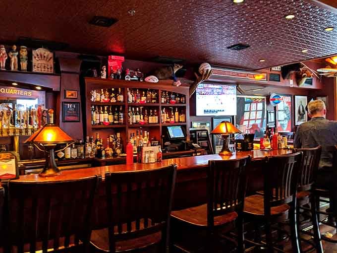 A well-stocked bar with amber lighting &ndash; where liquid courage meets liquid comfort in perfect harmony.