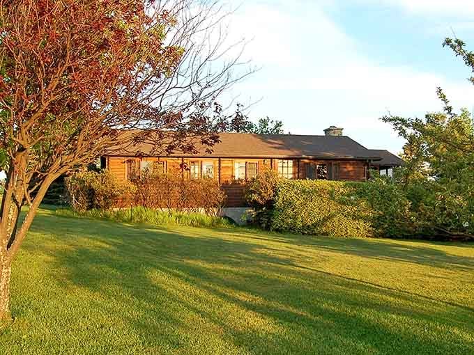 Golden hour hitting this cottage just right, making you question every life decision that doesn't involve a porch.