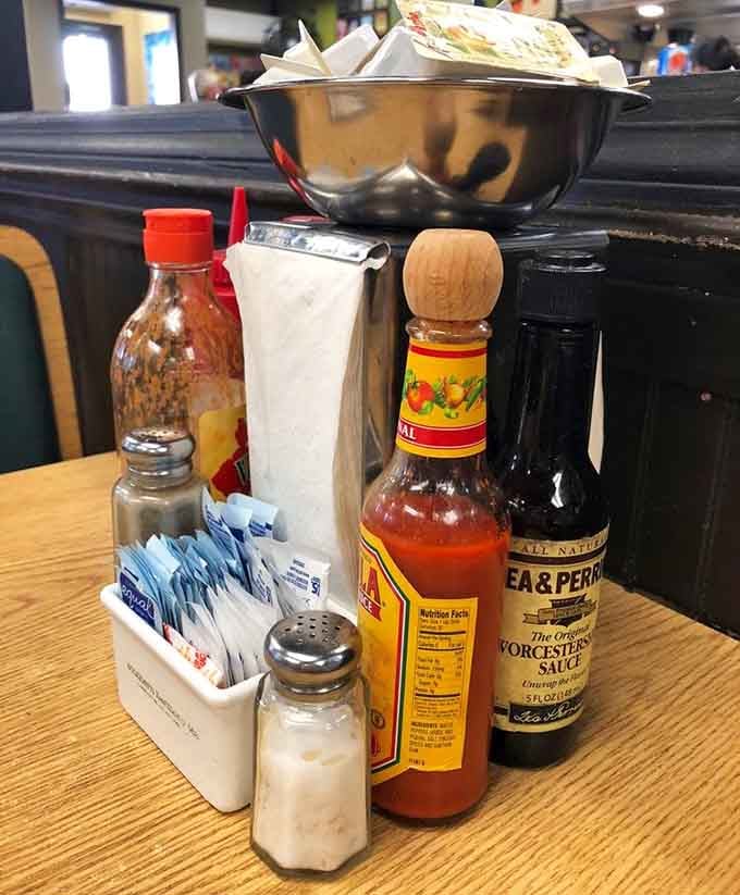 Table condiments including hot sauce and Worcestershire, the essential supporting cast members in every great breakfast performance that ever happened.
