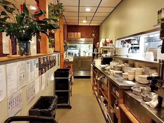 Behind the scenes where the magic happens, stacked plates ready for their moment carrying breakfast to grateful customers everywhere.